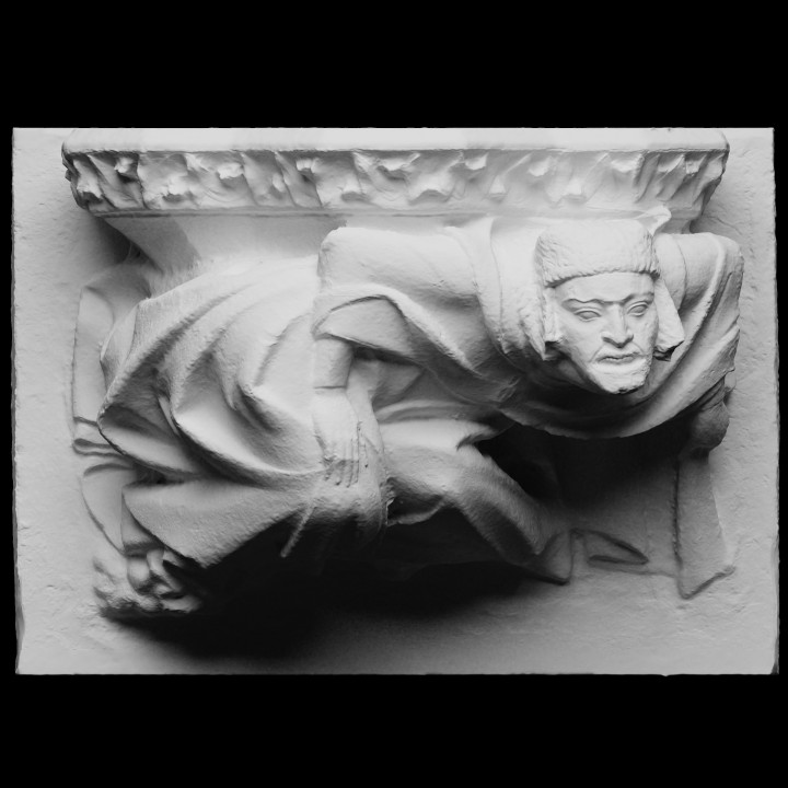 3D Printable Capital decorated with a grotesque man by Scan The World