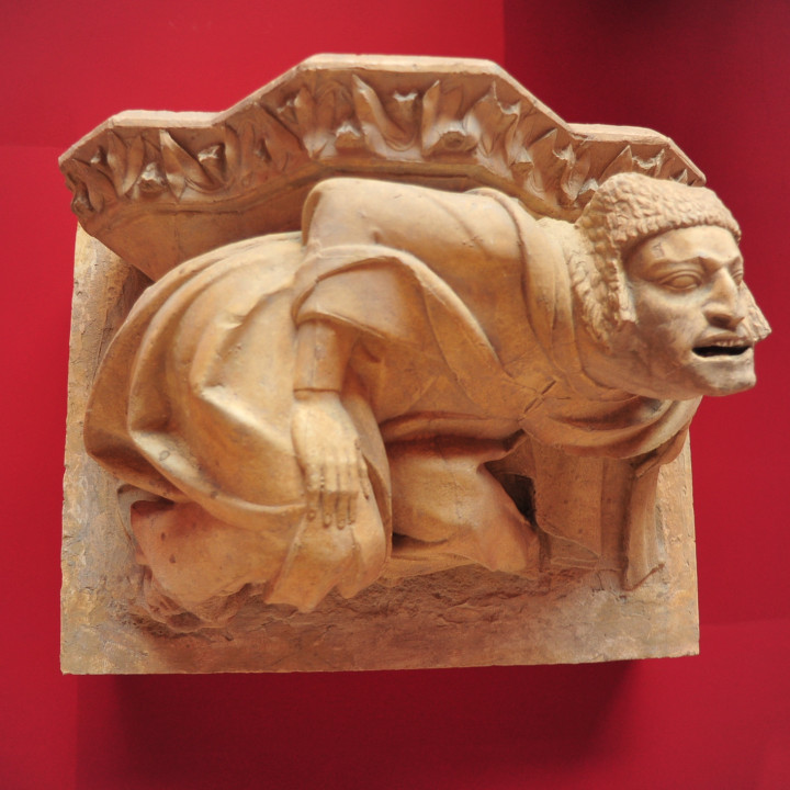 3D Printable Capital decorated with a grotesque man by Scan The World