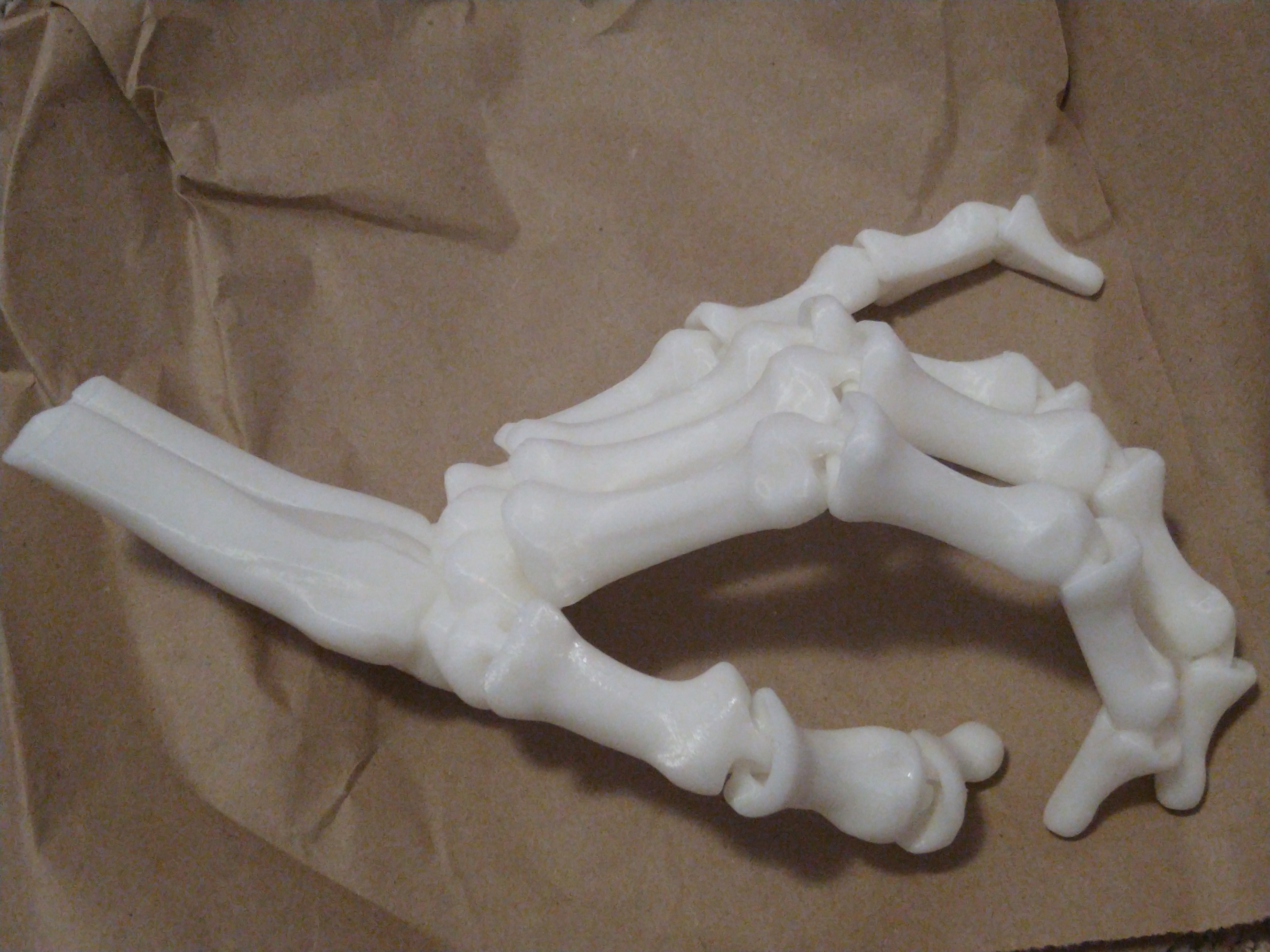 3D Printable FLEXI PRINT-IN-PLACE SKELETON HAND by Flexi Factory