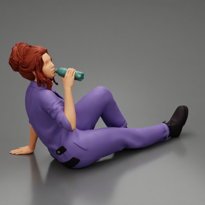 3D Printable Tired woman mechanic sitting and drinking water during ...