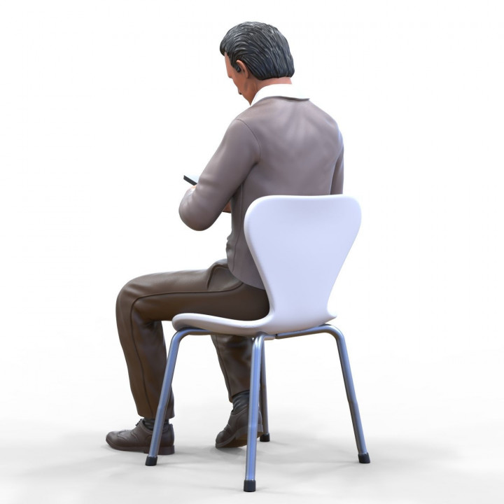 3D Printable A Man sitting on a chair with smartphone by 3DP Miniatures