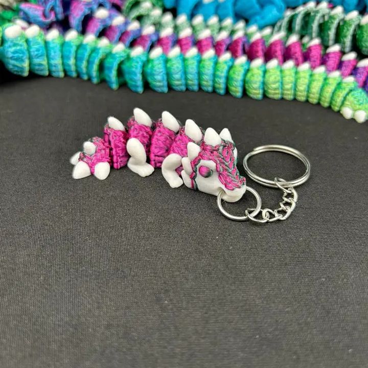 3D Printable Cozy Dragon Keychain by Built Over Bot