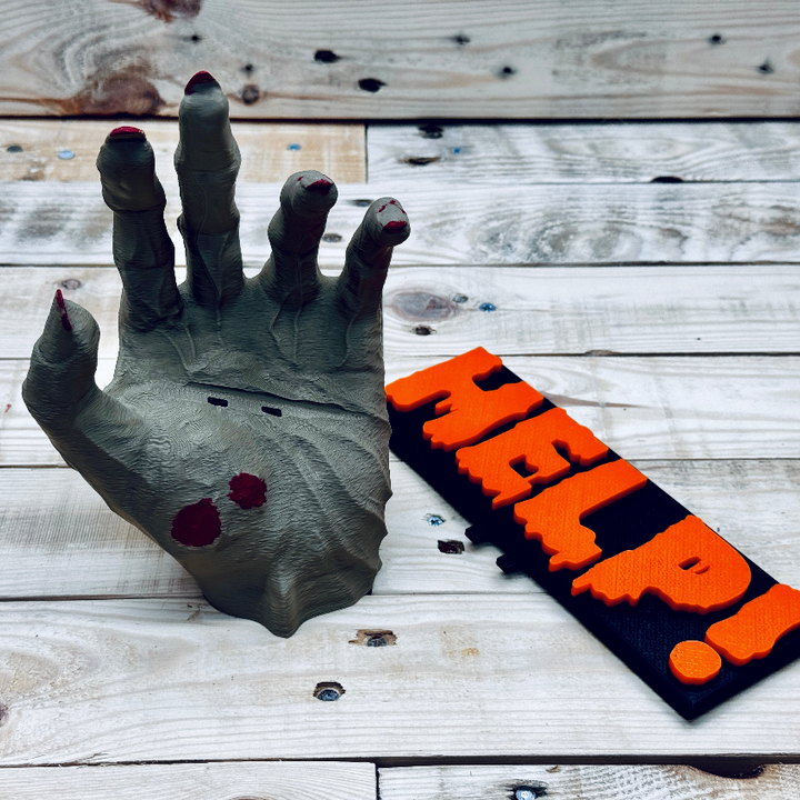 3D Printable Freestanding Zombies hand with Help sign by ENIQUE3D