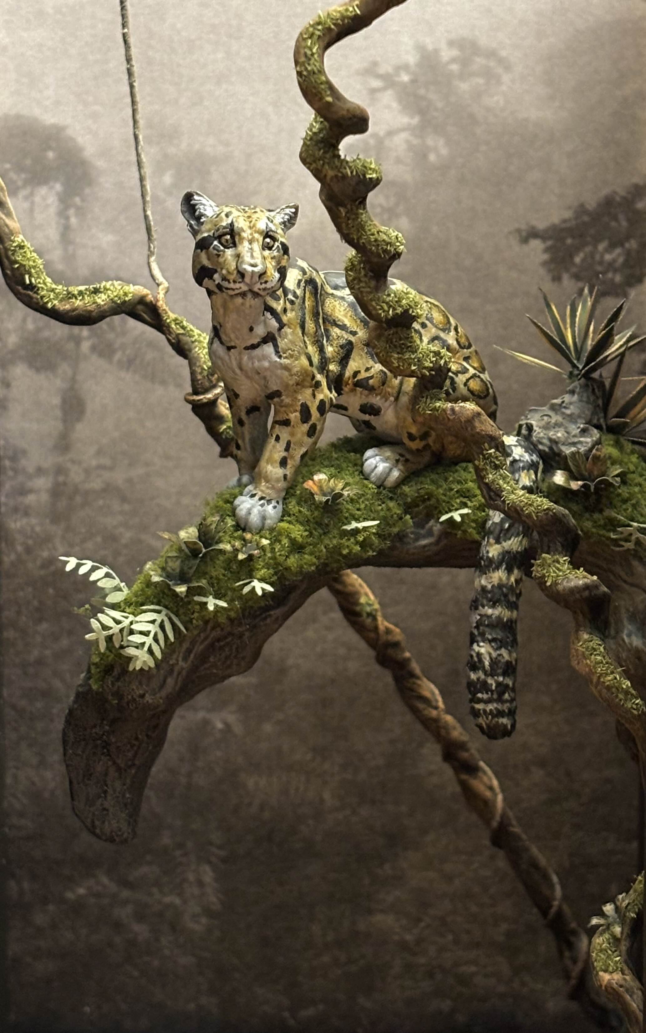 3D Printable Clouded Leopard on a Tree by Animal Den Miniatures