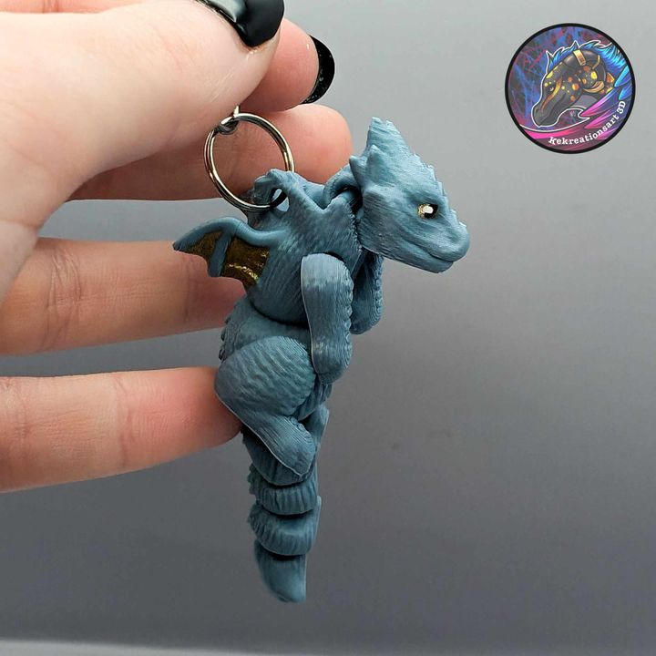 3D Printable Scruffed Baby Dragon Flexi Keychain by Kirsten M