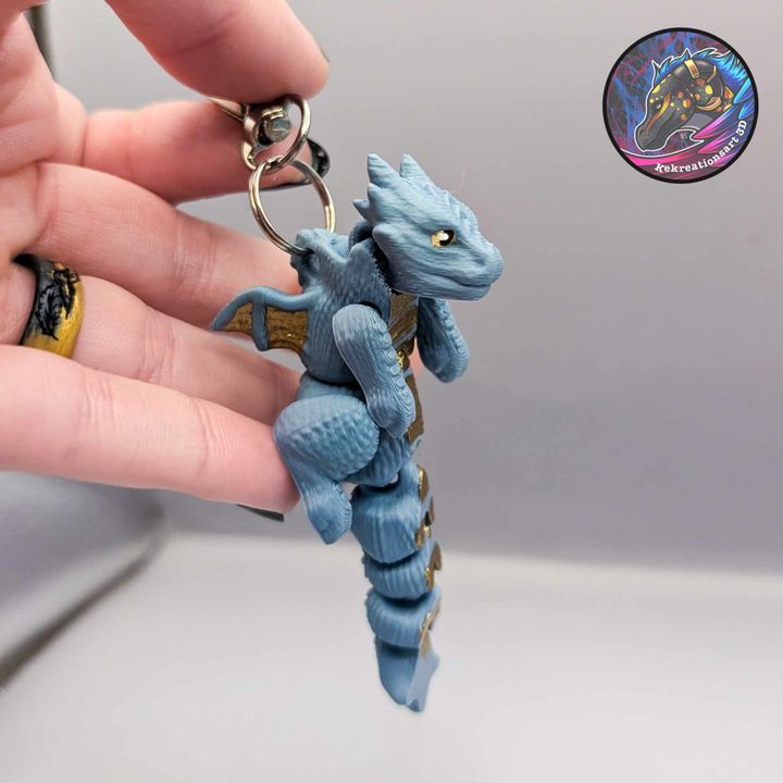 3D Printable Scruffed Baby Dragon Flexi Keychain by Kirsten M